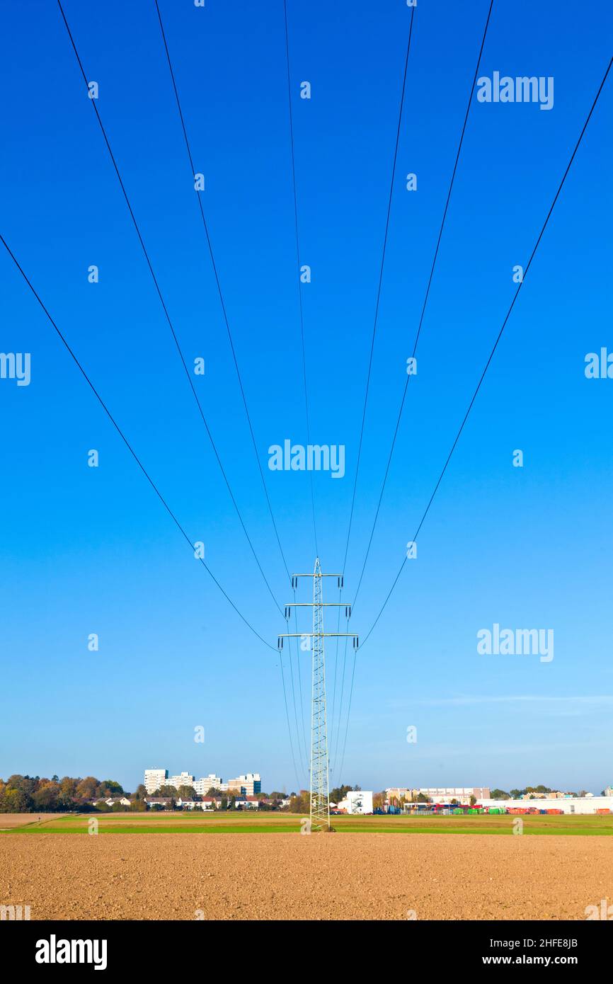 electrical tower in field under blue sky Stock Photo - Alamy