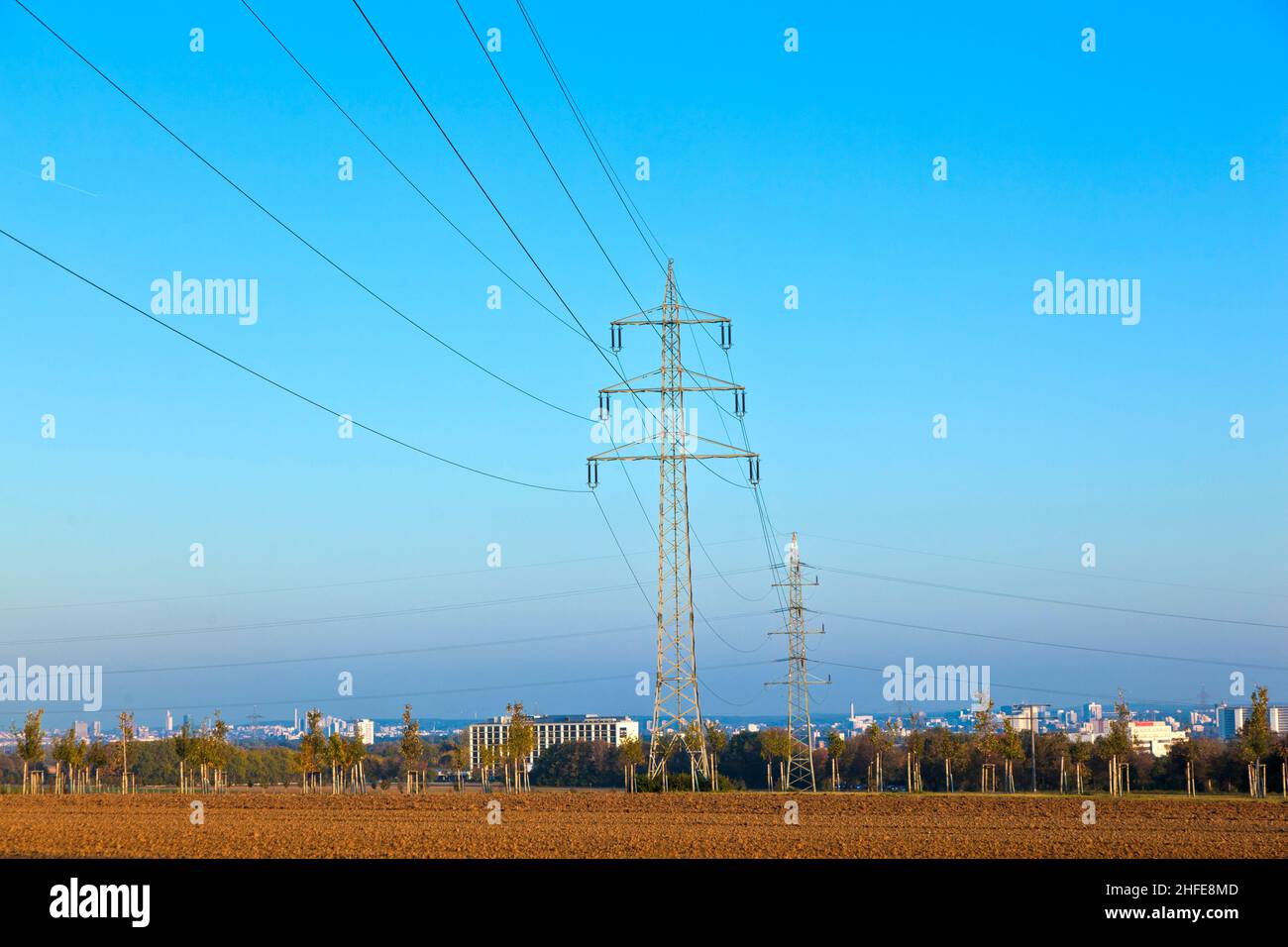electrical tower in field under blue sky Stock Photo - Alamy