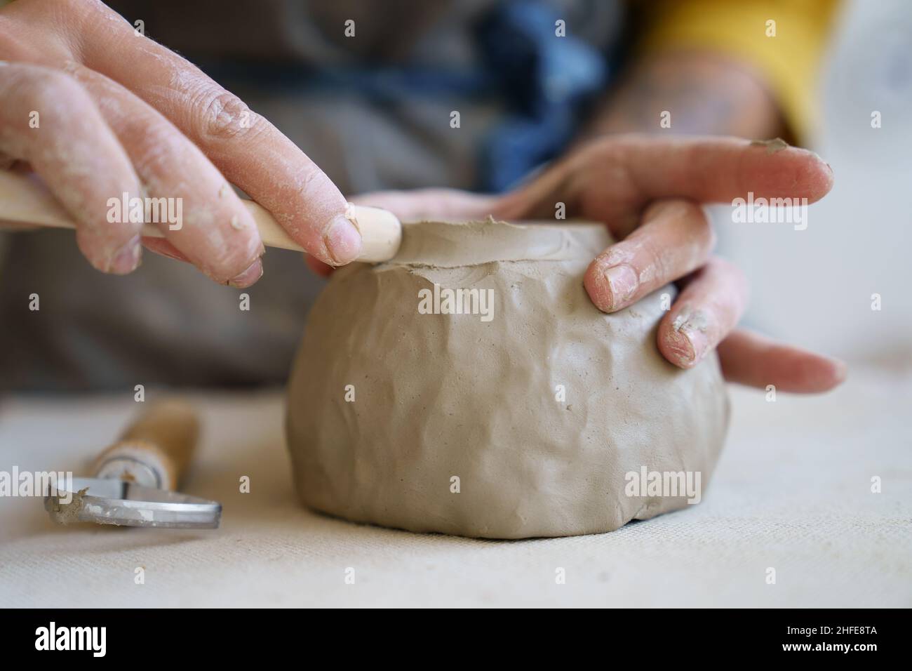 Ceramics creation process: female artist shaping and sculpting clay ...