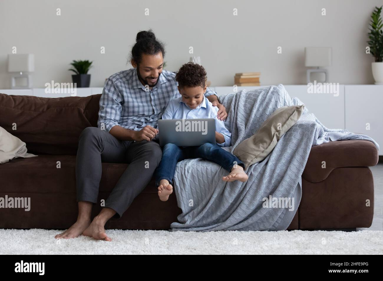 Happy gen Z kid and dad doing school homework together Stock Photo - Alamy