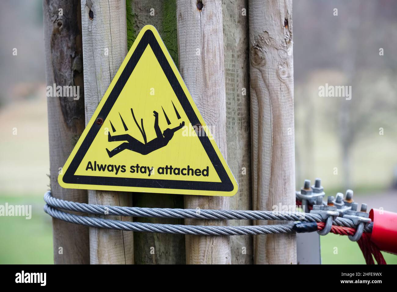 Adventure playground danger and risk sign on fence Stock Photo - Alamy