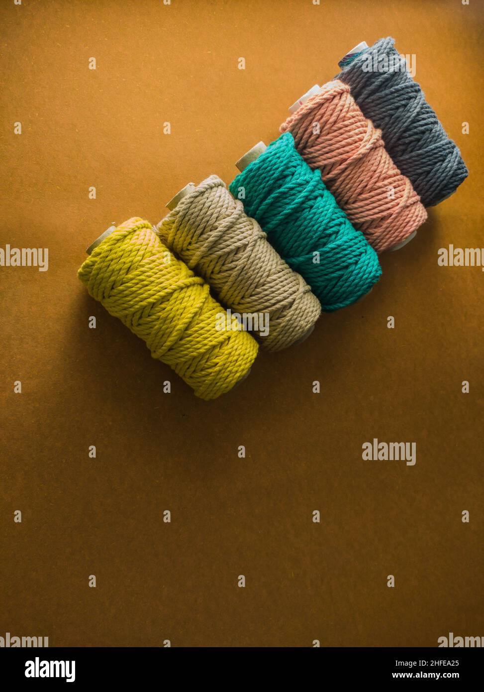 colorful reels of macrame cord threads or wool shot as copy space ...