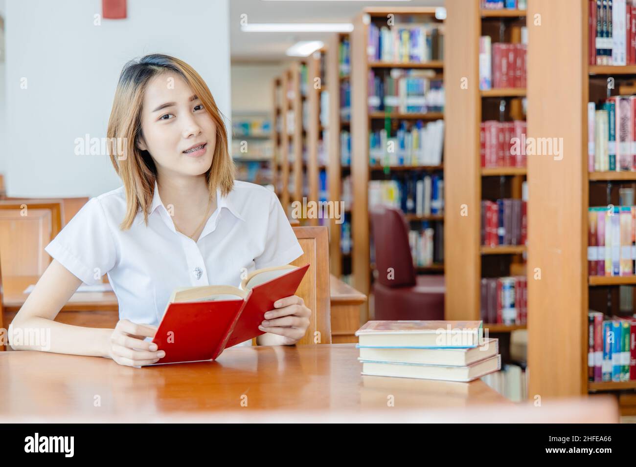 Portrait Asian university teen girl in library happy smile Stock Photo ...