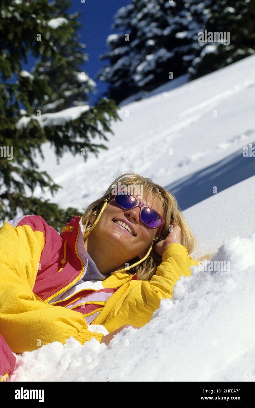 blond hair close up young woman portrait lay down on snow smiling ...