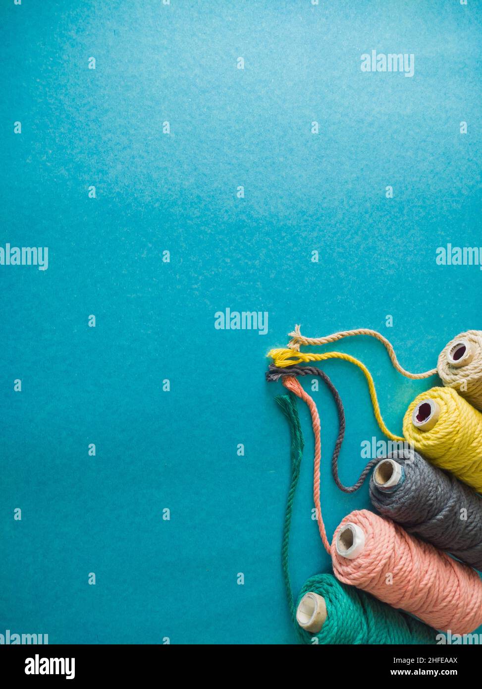 colorful reels of macrame cord threads or wool shot as copy space ...