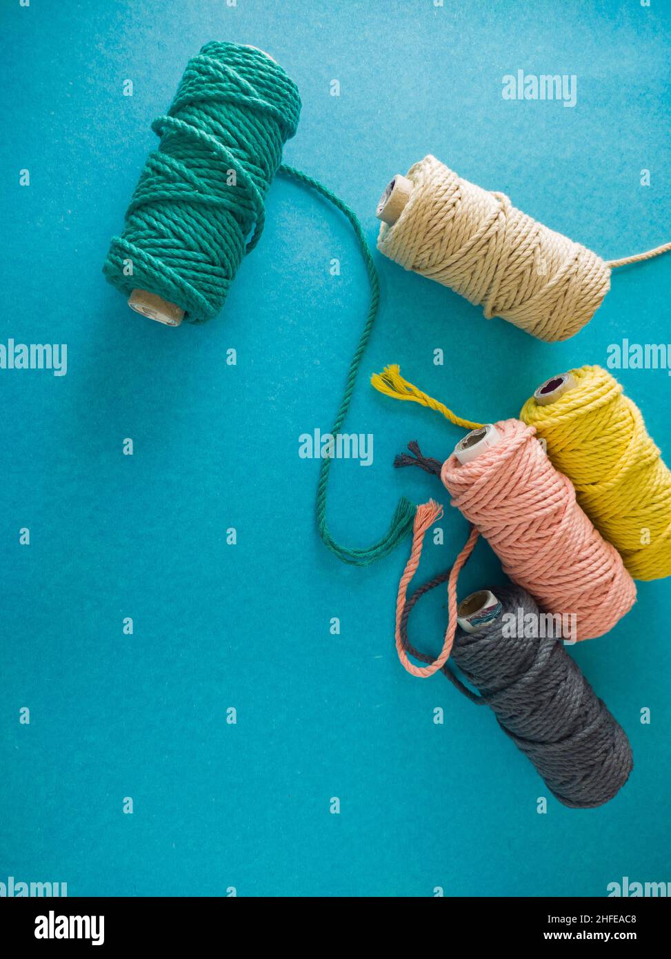 colorful reels of macrame cord threads or wool shot as copy space ...