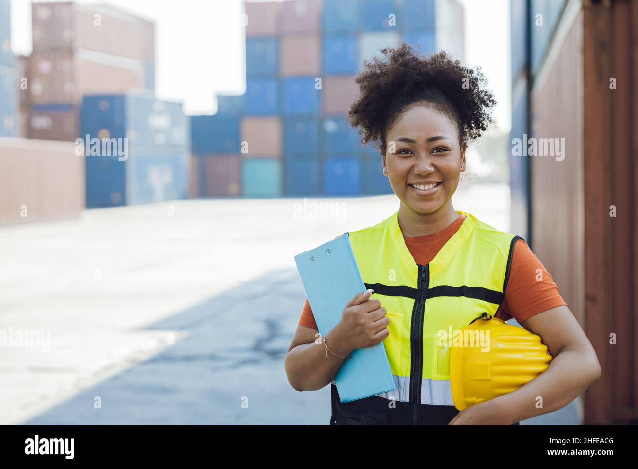 happy African women worker in port cargo shipping industry standing ...