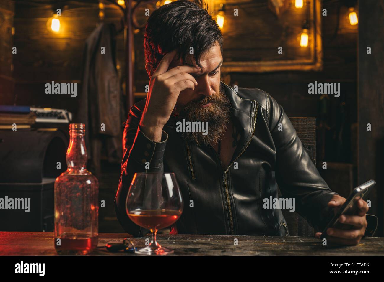 Handsome bearded businessman is drinking expensive whisky. Social media ...