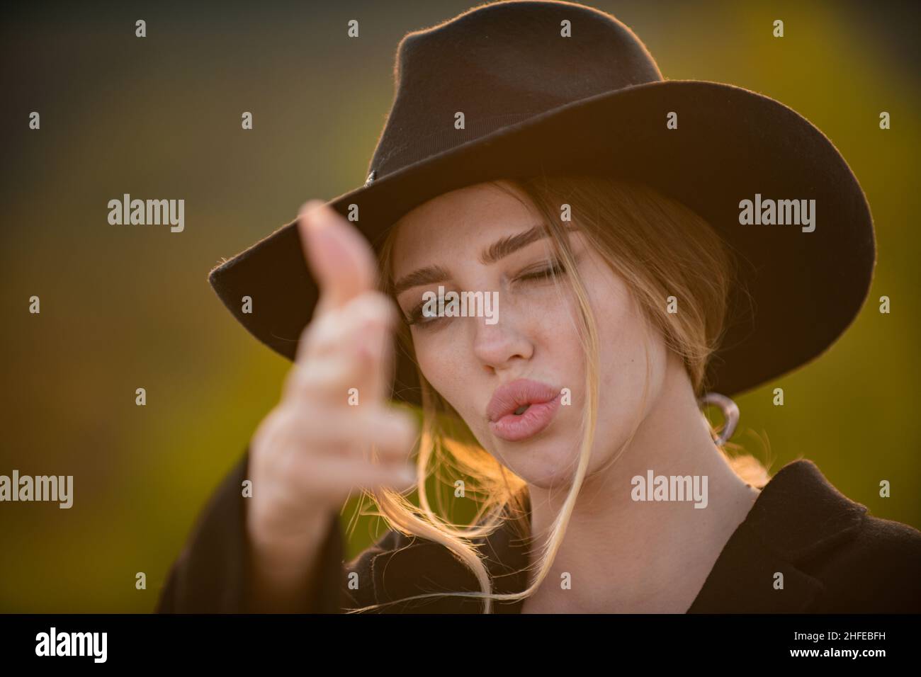 Western woman simulate shooting with and fingers, tender girl. Fashion ...