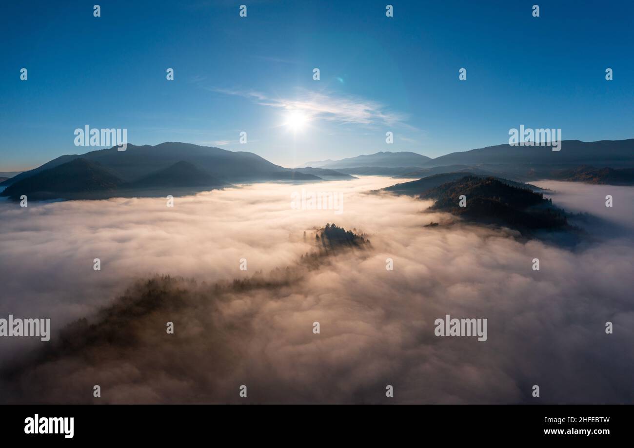 Mountains with terracotta and green trees growing under bright blue ...