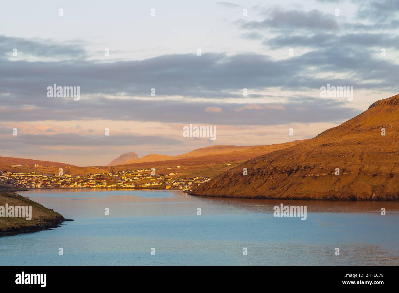 View of the small town of Sorvagur on the island of Vagar. Volcanic ...