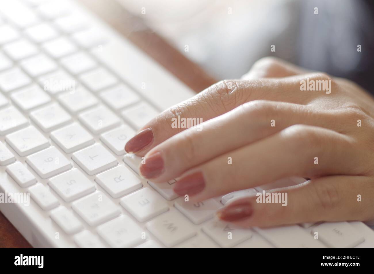 Close-up view woman hands typing on white keyboard Stock Photo - Alamy