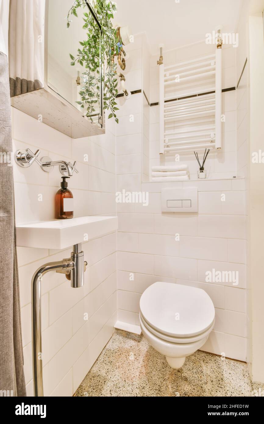 Adorable restroom with toilet and radiator above it Stock Photo - Alamy