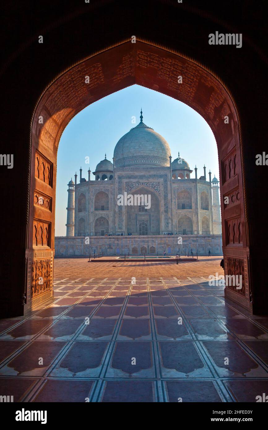 Taj Mahal in India in backlight seen from the arch of the mosque in ...