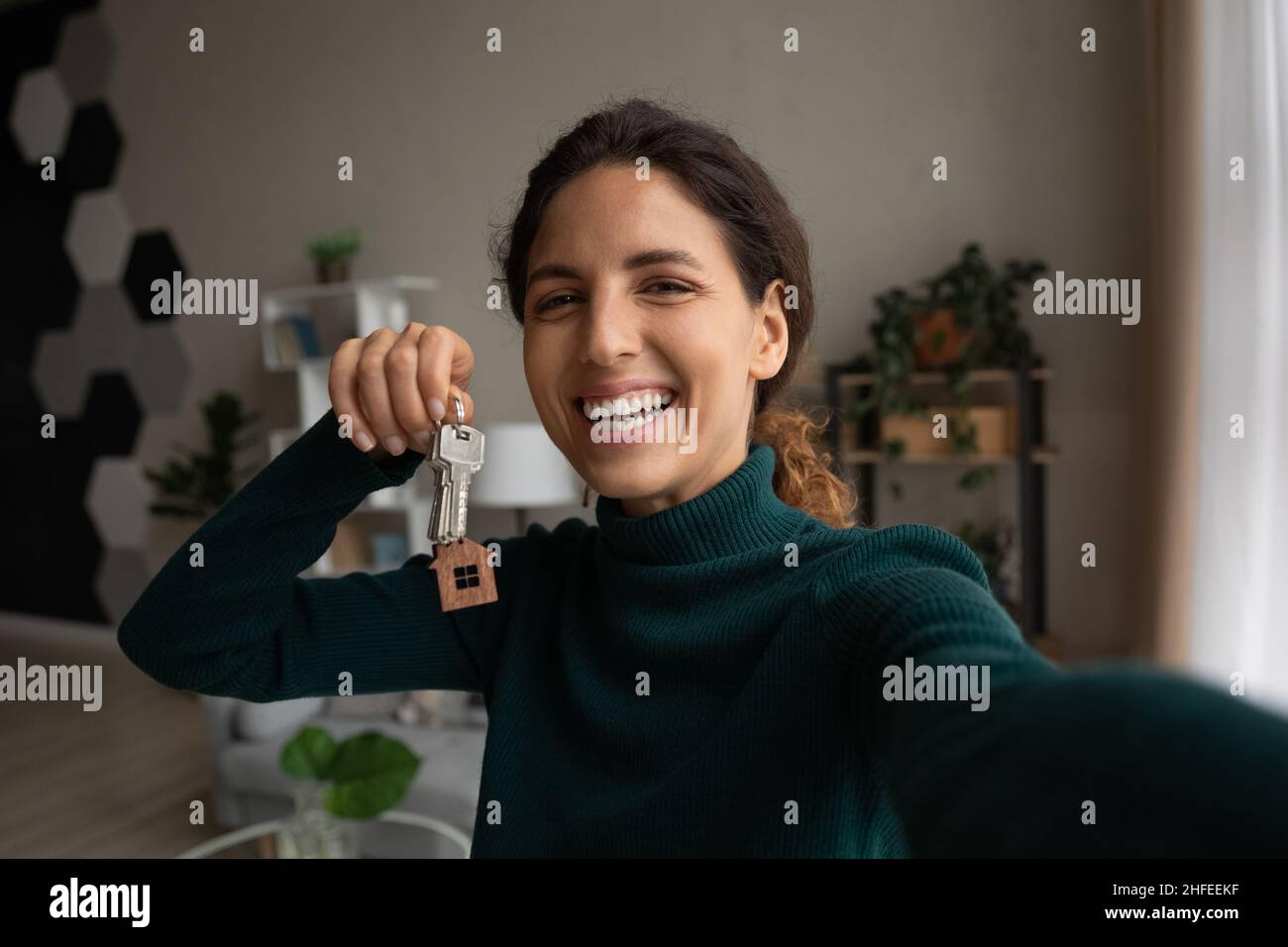 Happy young woman holding keys in hands, recording selfie video Stock ...