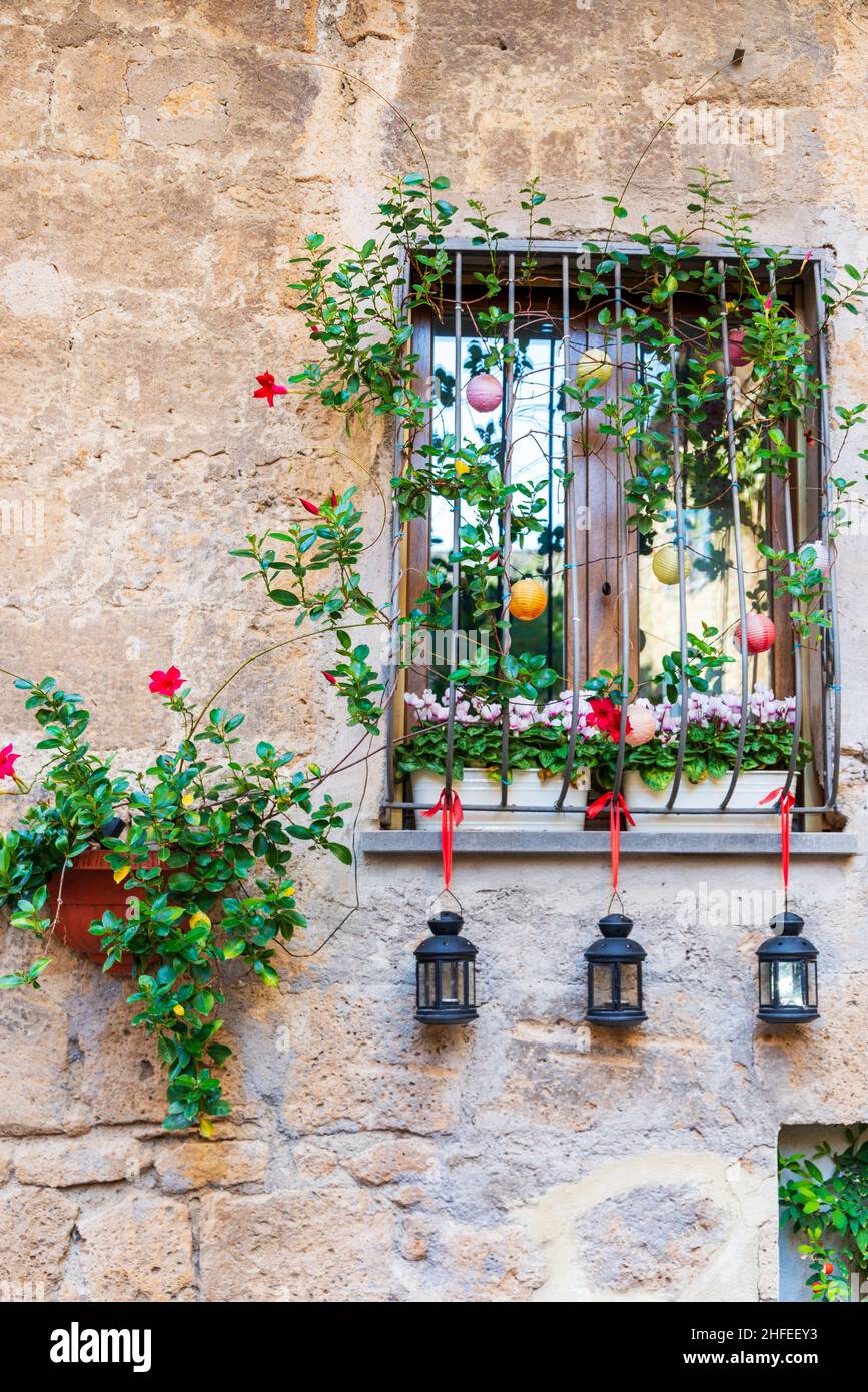 Italian window decorated with flowers and flower boxes Stock Photo - Alamy