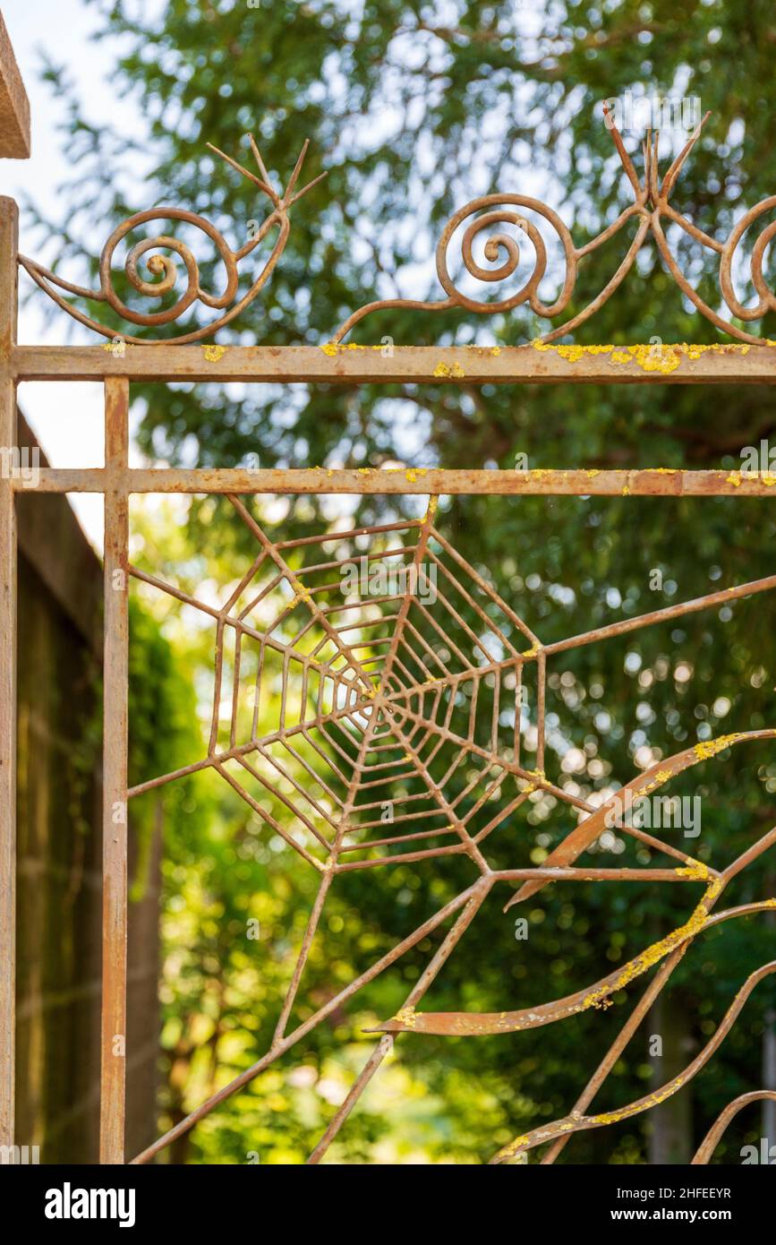 Part of an ornamental gate with decorative spider webs and snails Stock ...