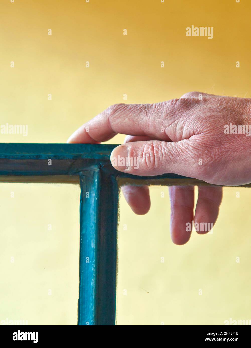 hand with bracelet leaning on a window frame Stock Photo - Alamy