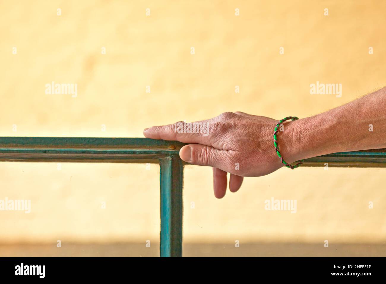hand with bracelet leaning on a window frame Stock Photo - Alamy