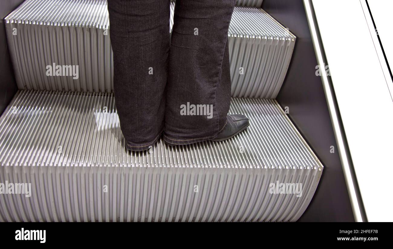 feet of woman on moving staircase Stock Photo - Alamy