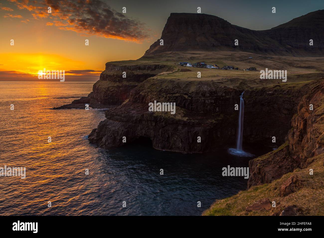 View of Mulafossur Waterfall and surrounding coastline from afar ...