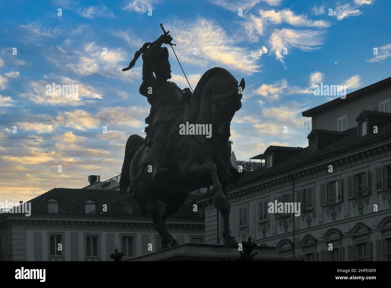 Backlight view of the equestrian statue of Emmanuel Philibert, Duke of Savoy, against sunset sky ...