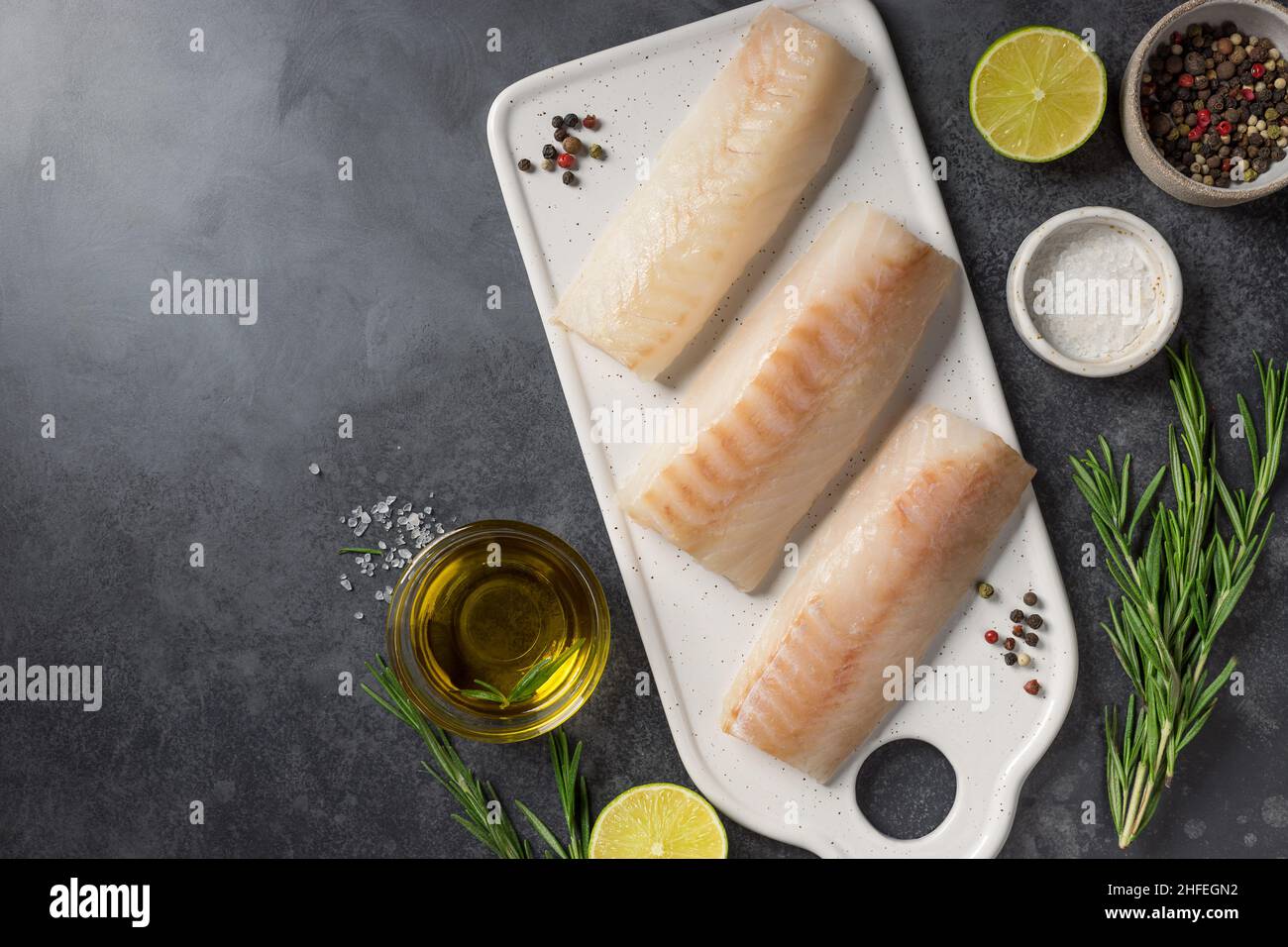 Fillet of white cod fish with lime, rosemary, spices Stock Photo - Alamy