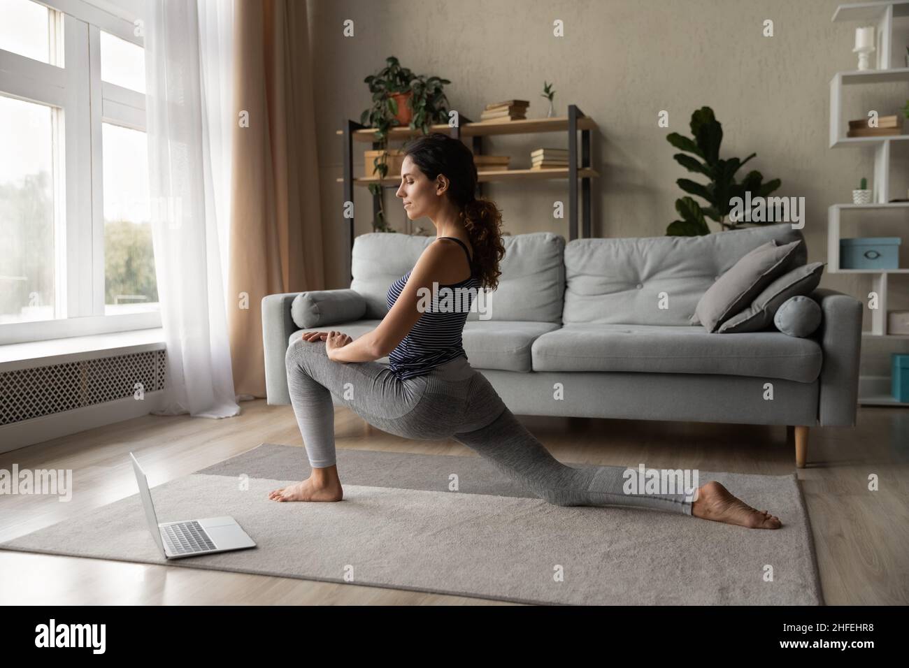 Happy active young woman enjoying online workout class. Happy active ...