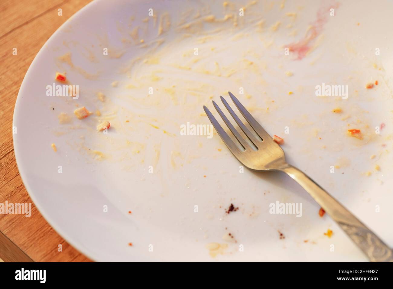 DIRTY PLATE AND TABLEWARE AFTER a MEAL. Top view of empty plate, dirty ...