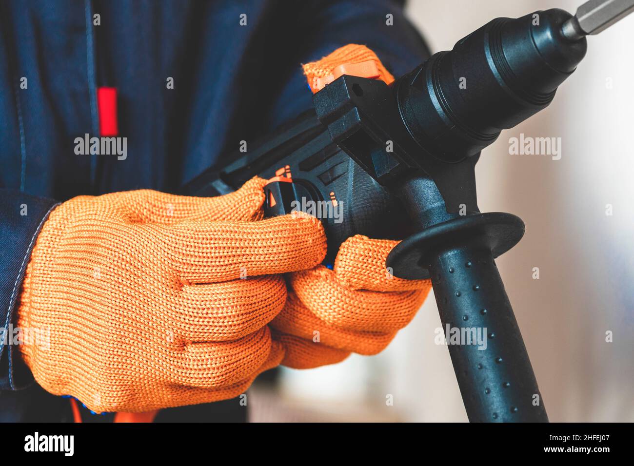 workman switches directions to a rotary hammer. Hands change of ...