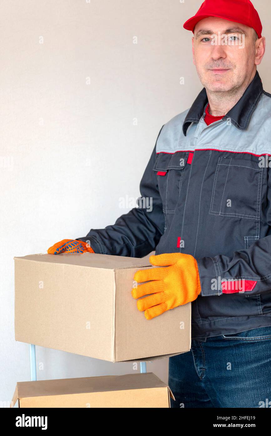 delivery man holding package. Courier holding box. man carrying ...