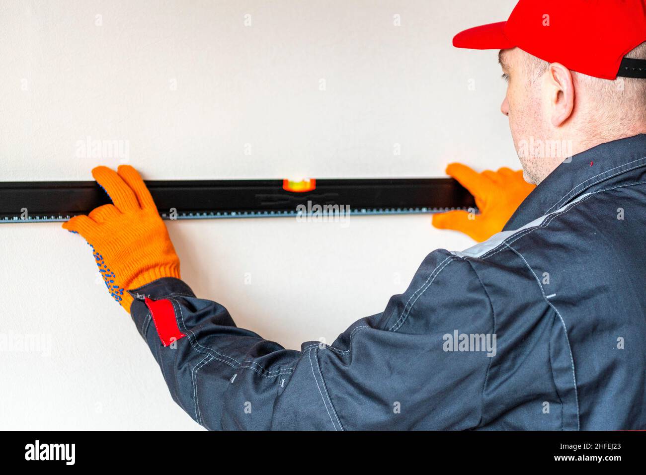 Worker with bubble level. measuring with bubble level.Measurement ...