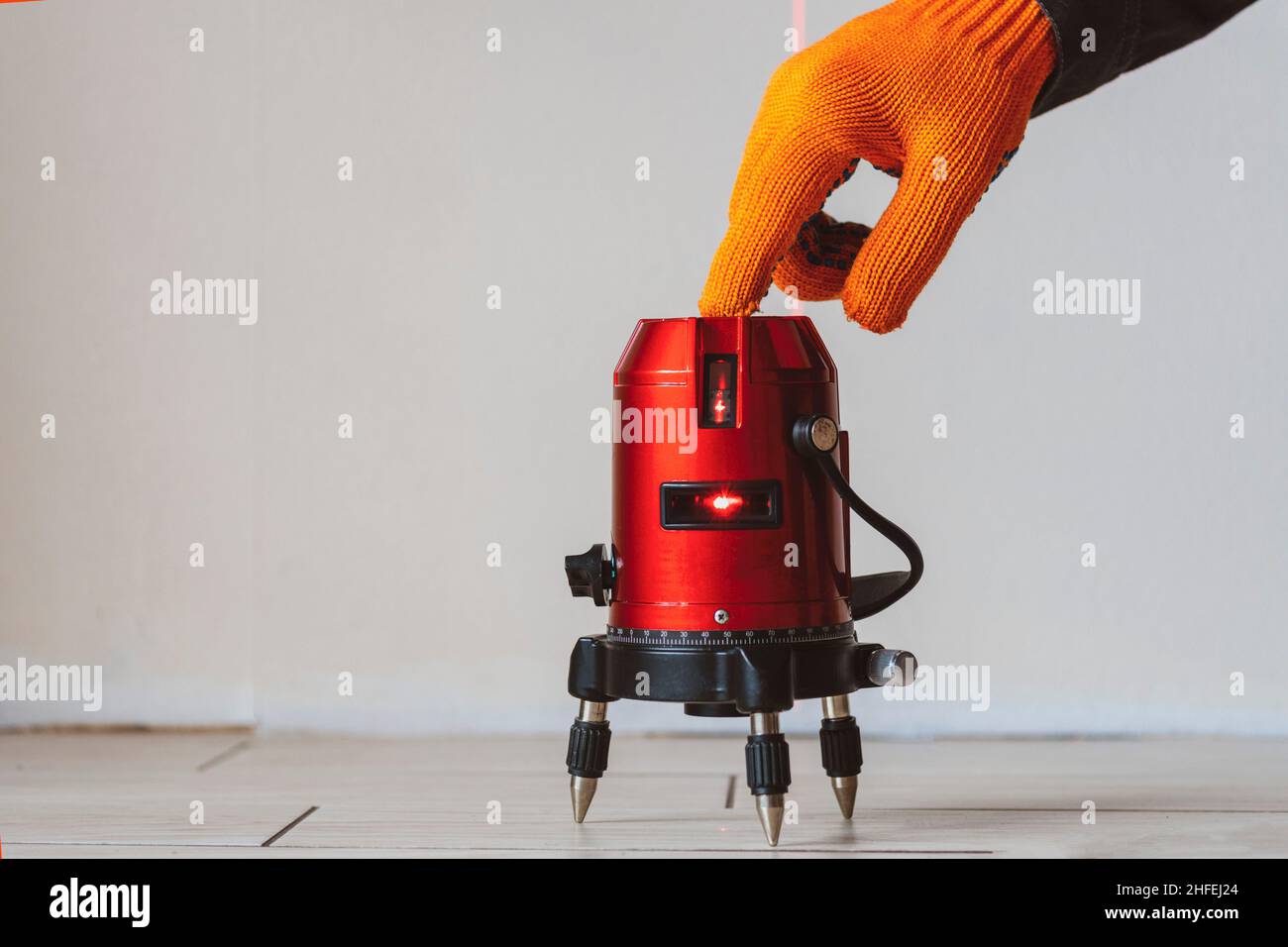 Worker and Bubble,laser level. measuring with red laser level ...