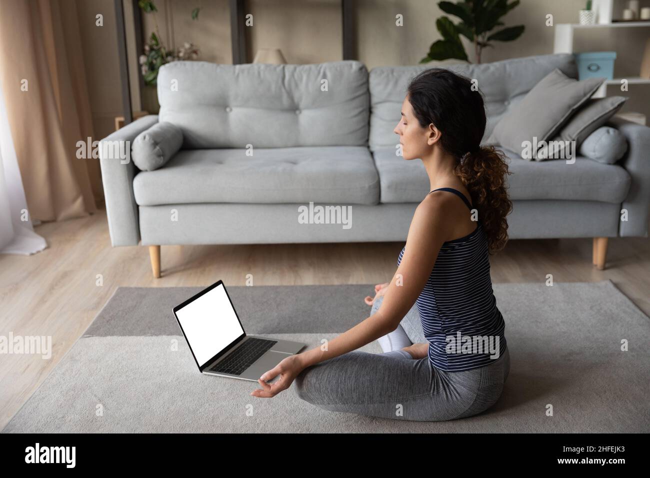 Young mindful woman meditating home hi-res stock photography and images ...