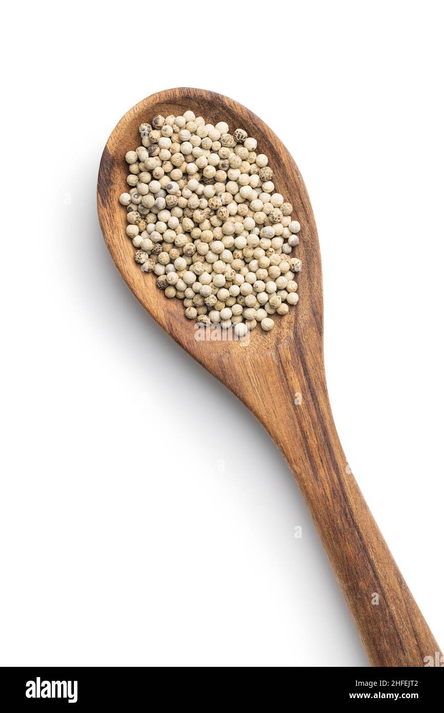 Whole pepper spice. White peppercorn grain in wooden spoon isolated on ...