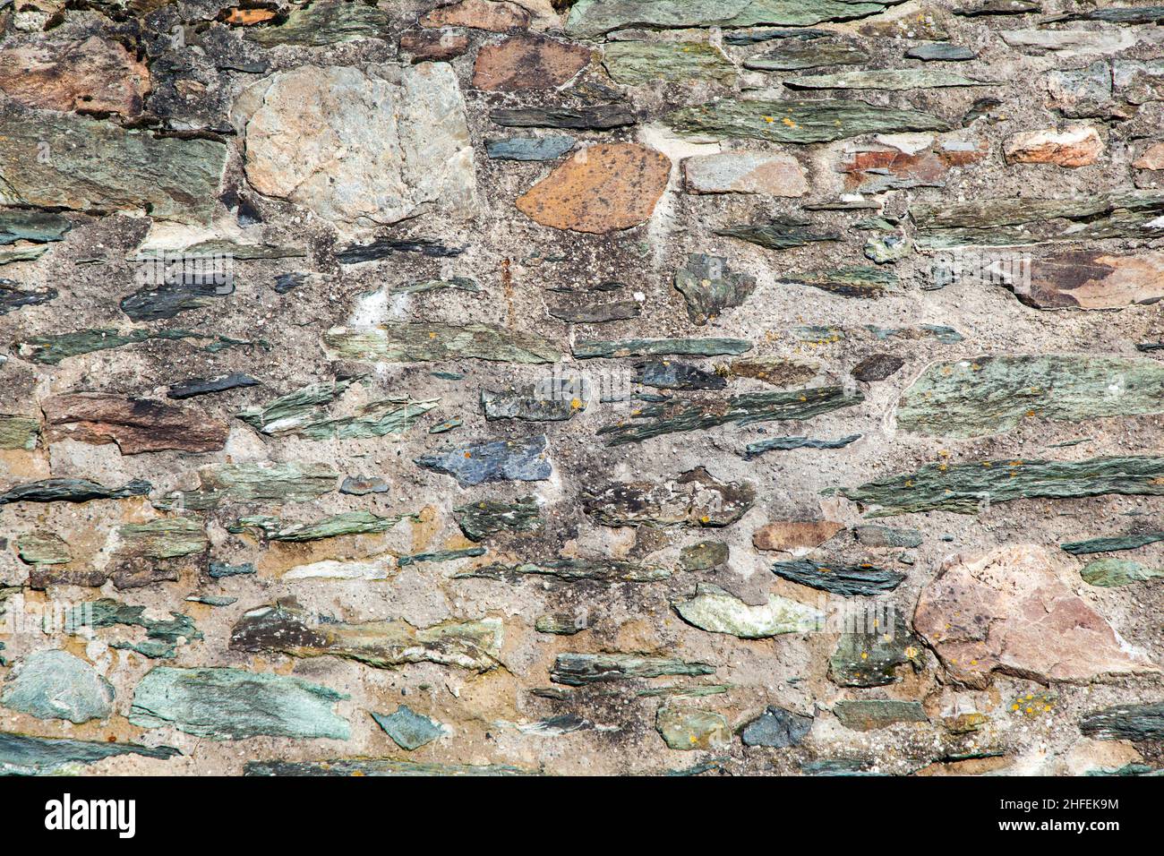 Wall built of rough natural stones in various sizes Stock Photo - Alamy