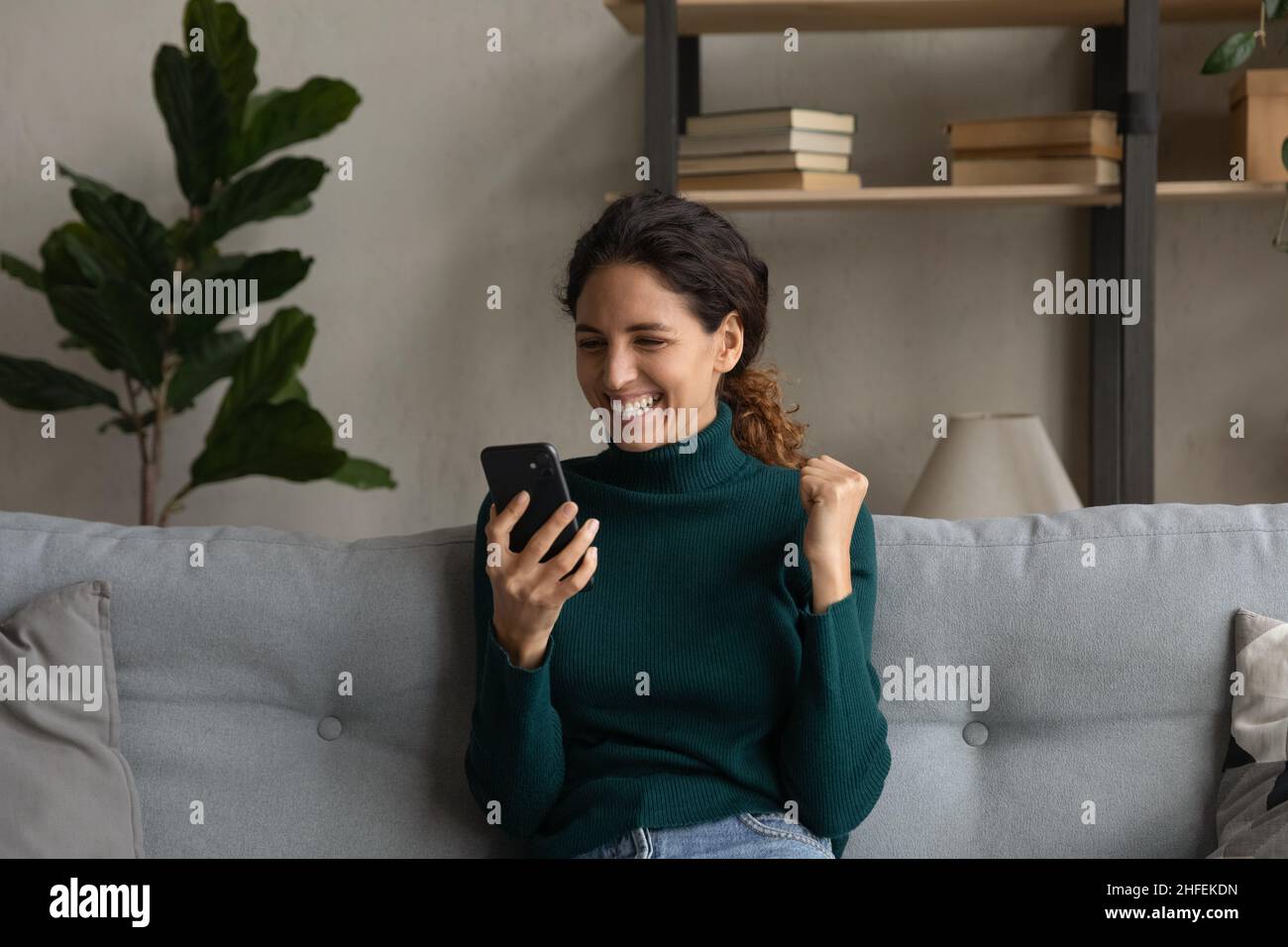 Emotional happy laughing woman celebrating online win Stock Photo - Alamy