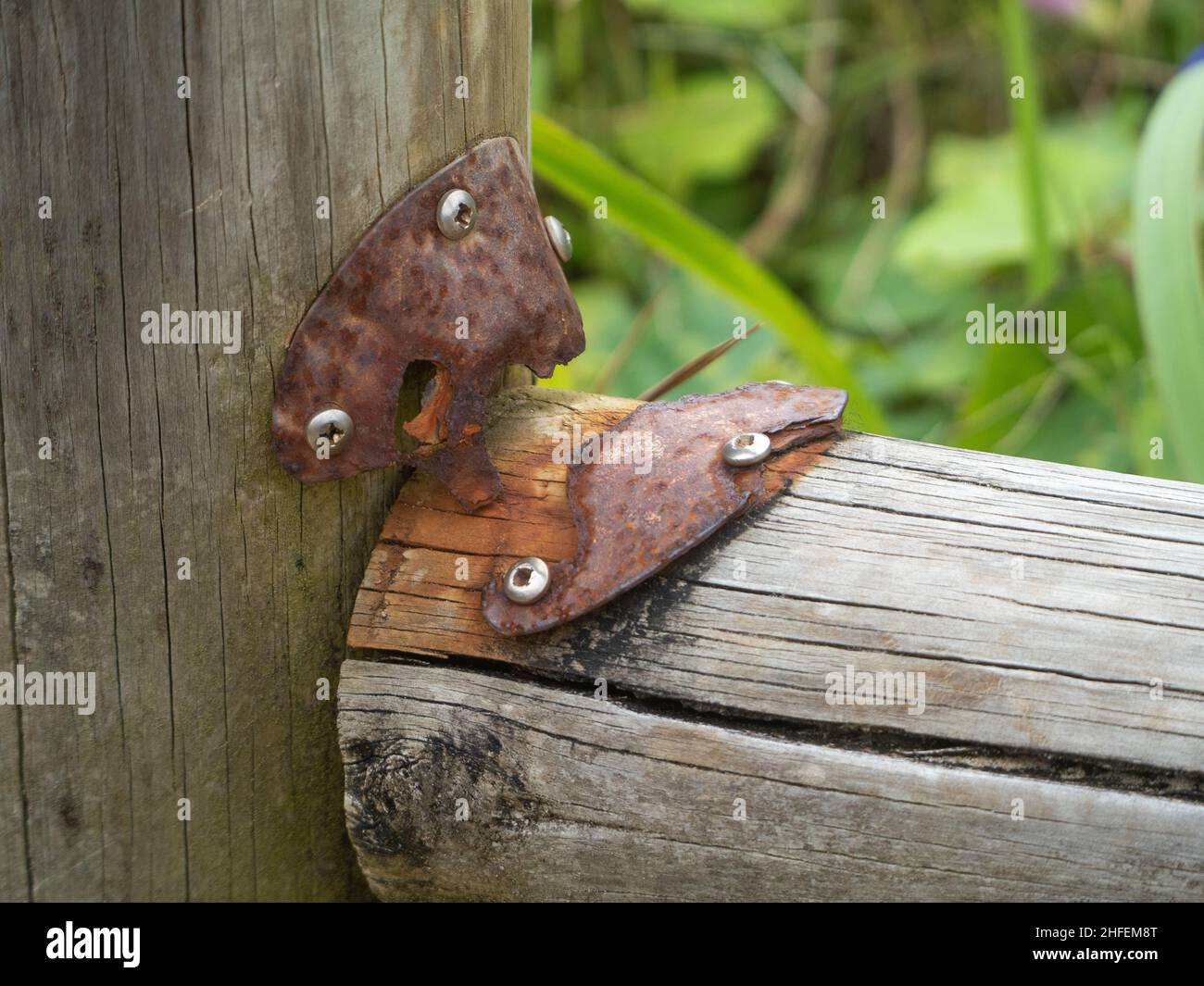 A rusty metal connector that joined two wooden posts, rusted out and ...
