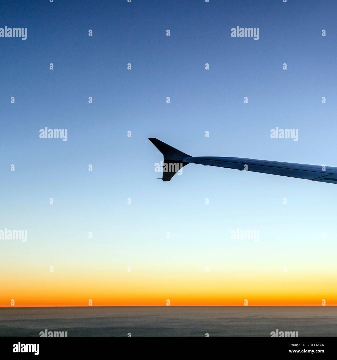 wing of aircraft in sunrise Stock Photo - Alamy