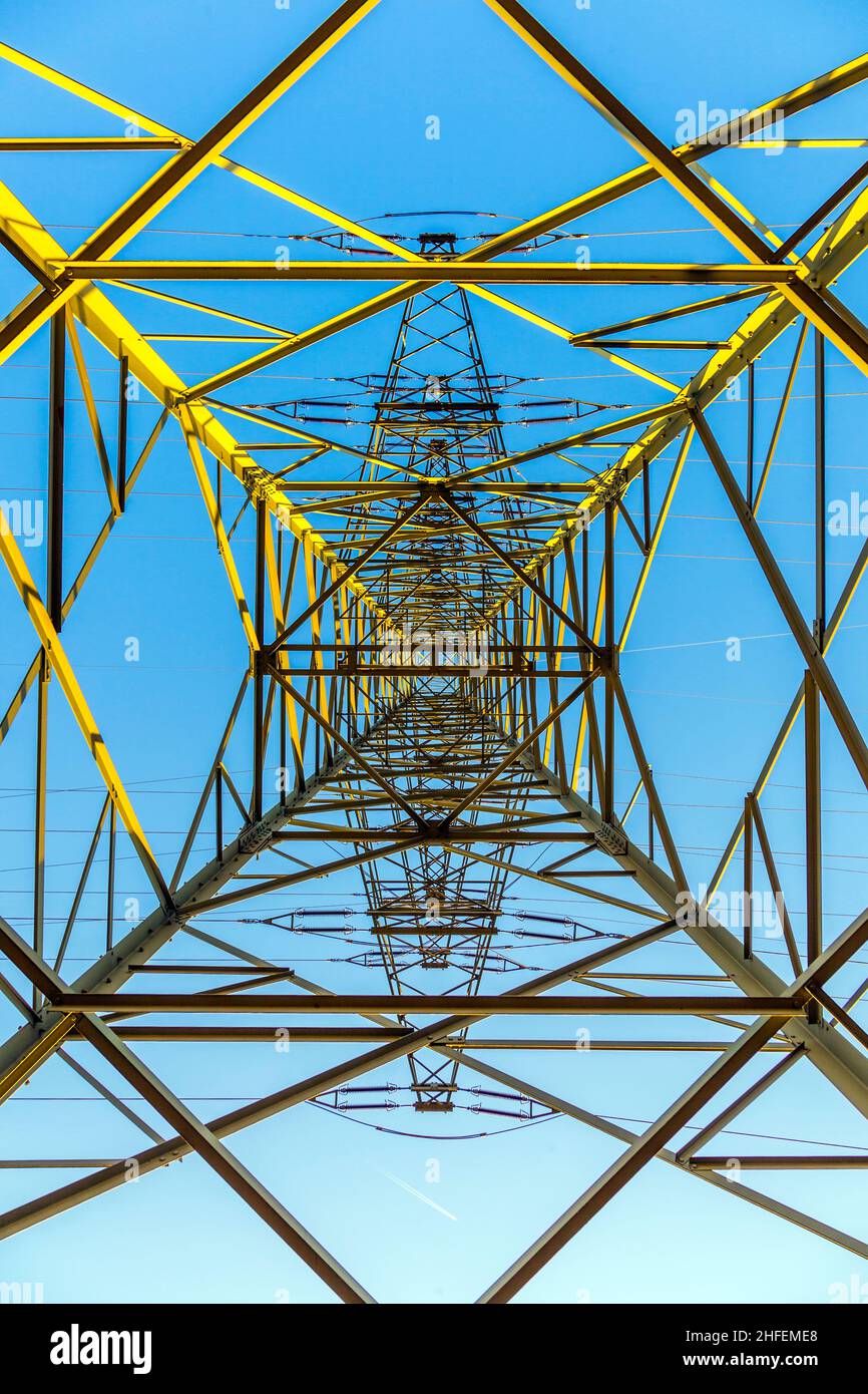 electrical pylon under blue sky, power line cable Stock Photo - Alamy
