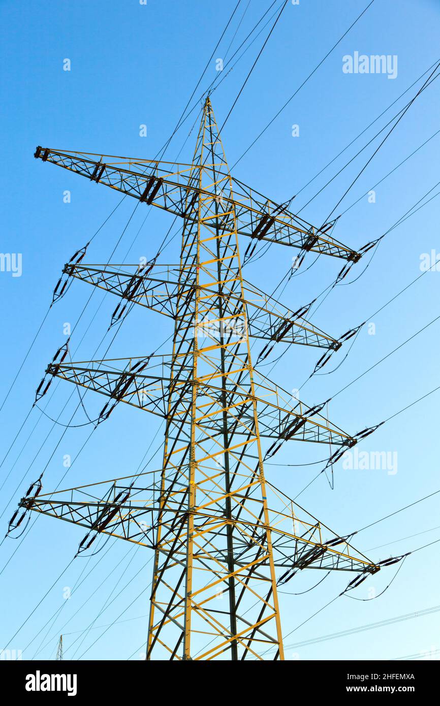 electrical pylon under blue sky, power line cable Stock Photo - Alamy