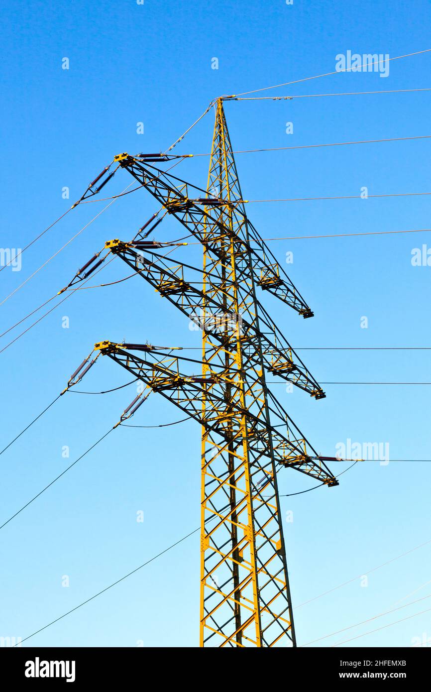 electrical pylon under blue sky, power line cable Stock Photo - Alamy