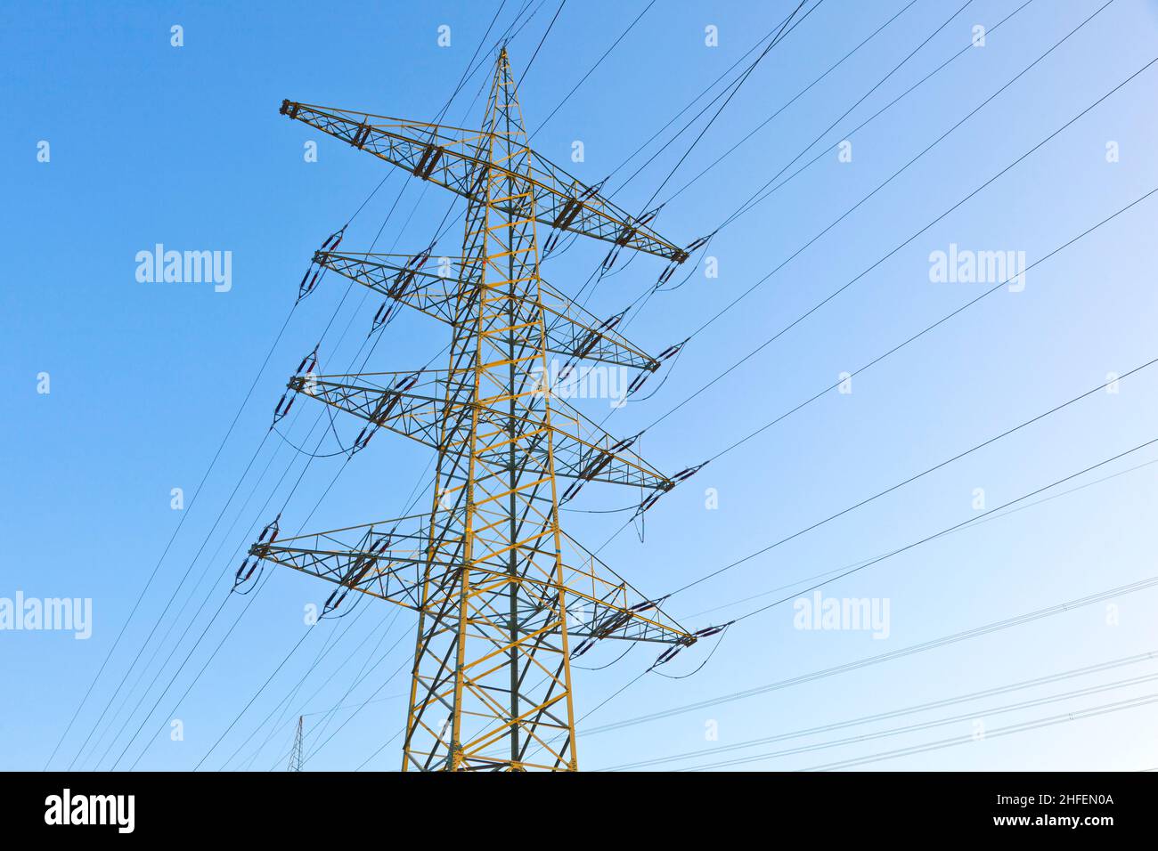 electrical pylon under blue sky, power line cable Stock Photo - Alamy