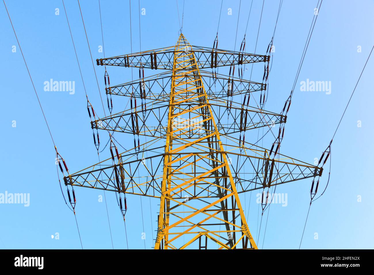 electrical pylon under blue sky, power line cable Stock Photo - Alamy