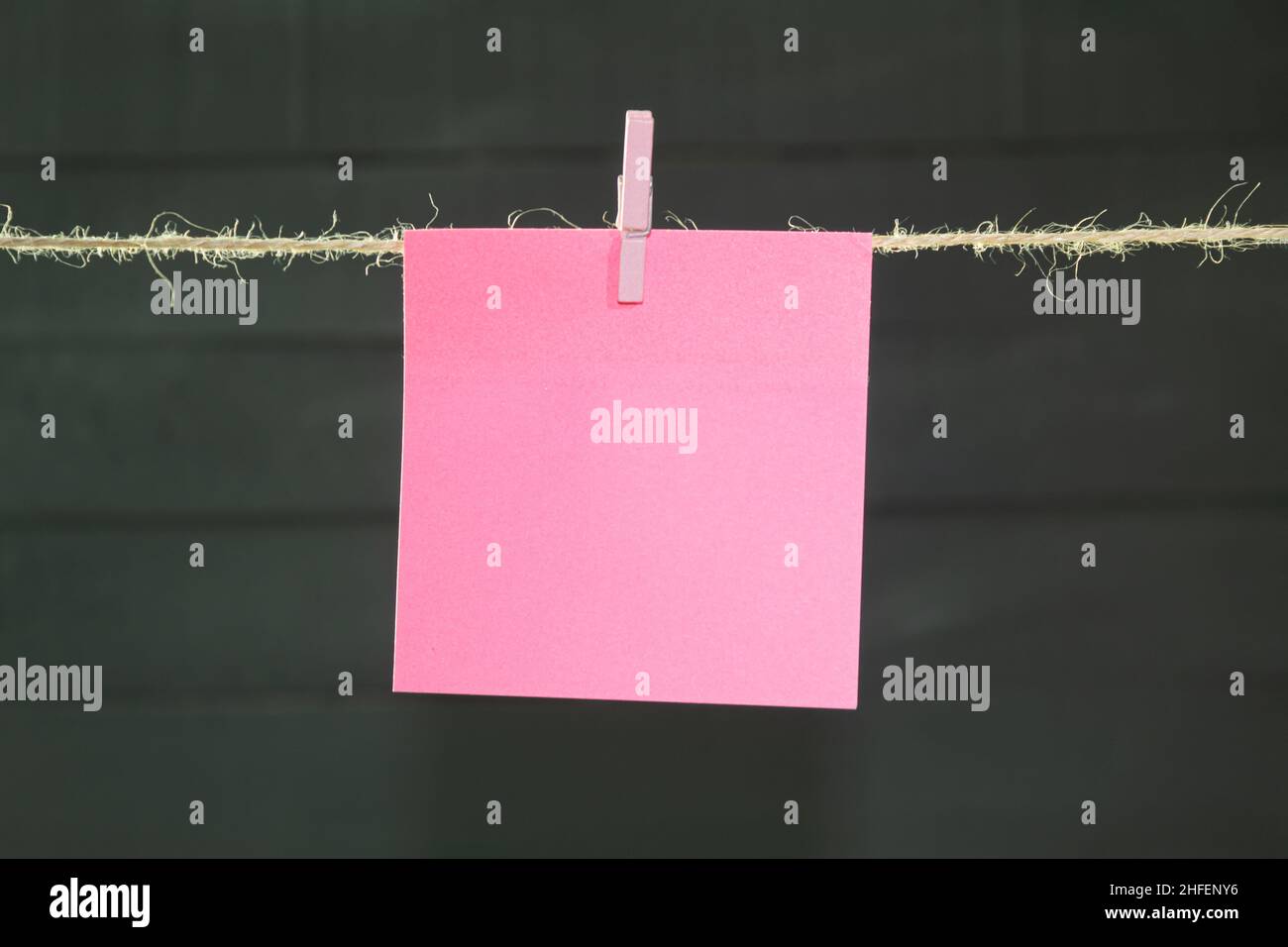 The paper for the text is suspended from a rope. Photo frames hanging ...