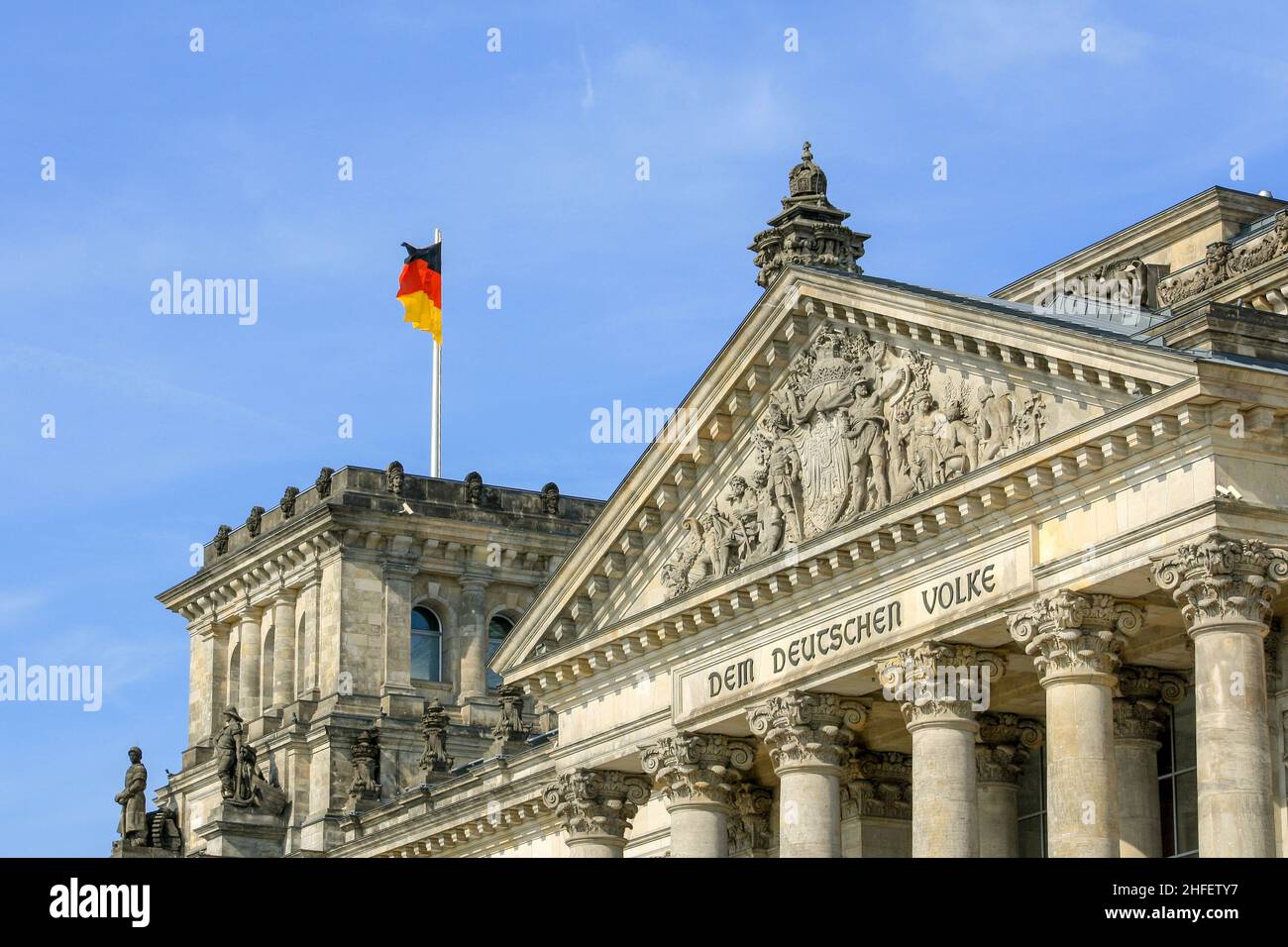 Exterior of Reichstag building with Germany flag on top in summer blue ...