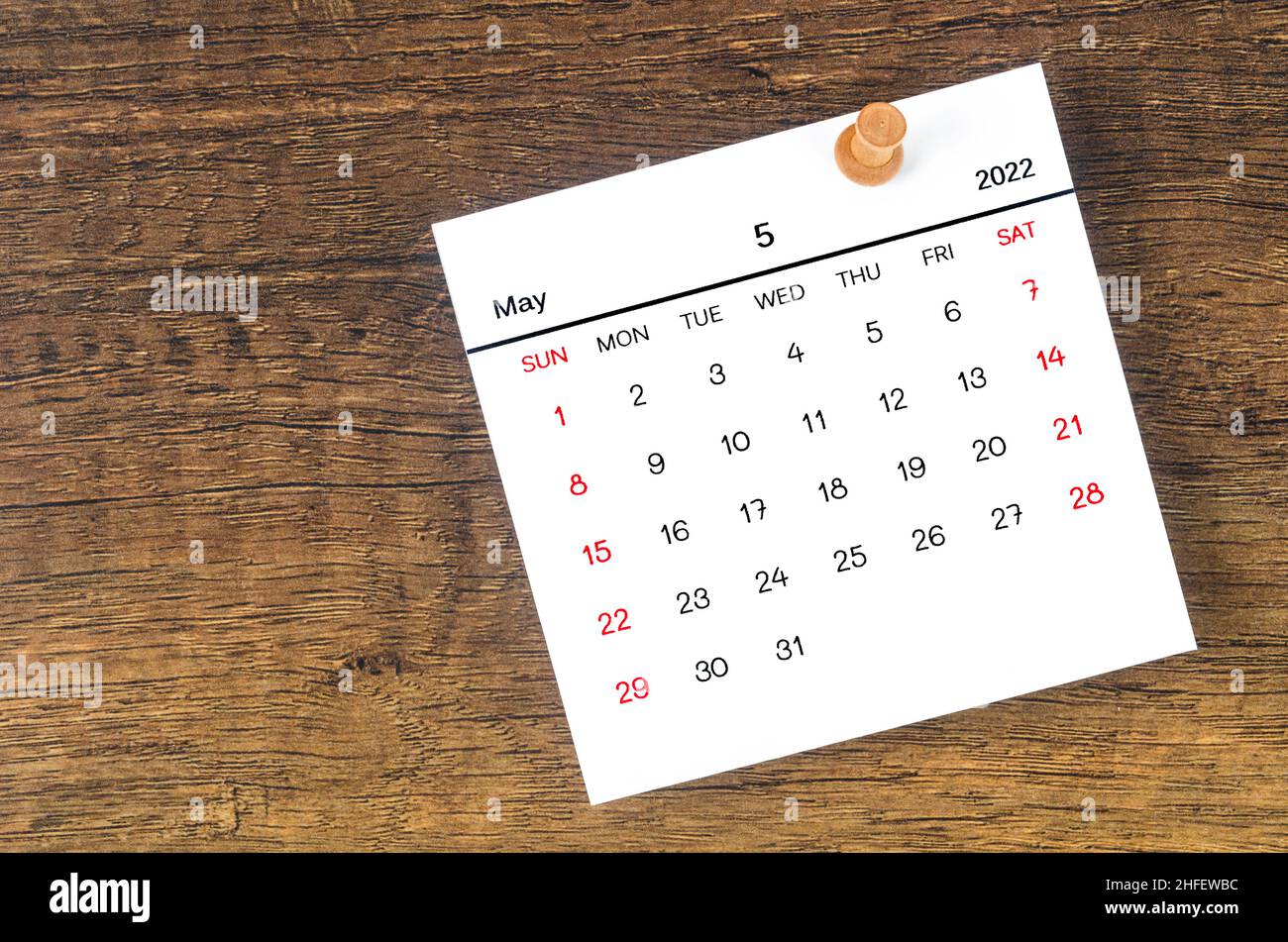 The May 2022 calendar and wooden push pin on wooden background Stock ...