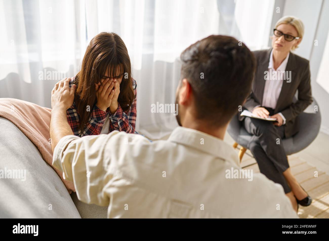 Sad couple arguing disagreement at psychologists office Stock Photo - Alamy
