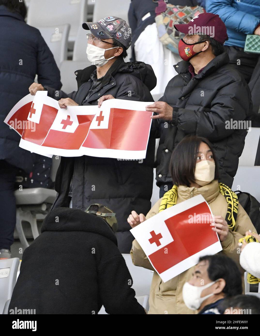 Spectators show flags of Tonga in support of the underwater volcanic ...