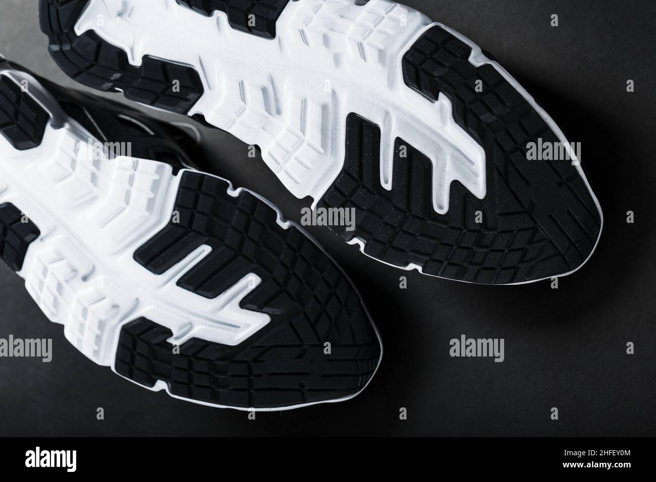The black and white sole of trendy sports sneakers is a close-up in ...